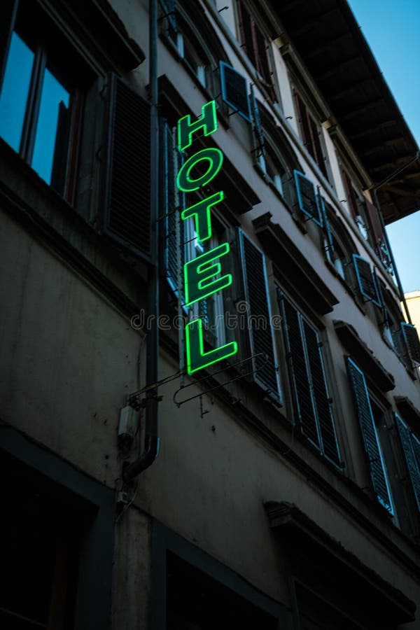 Vertical Shot of a Building Facade with an Illuminated Sign of "HOTEL ...