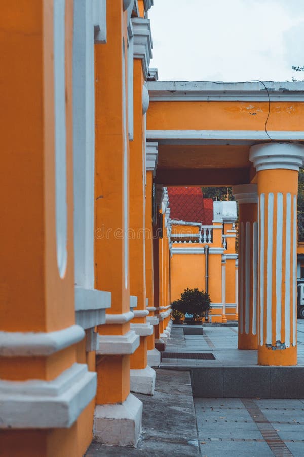 Vertical Shot of a Building with Orange and White Columns. Stock Photo ...