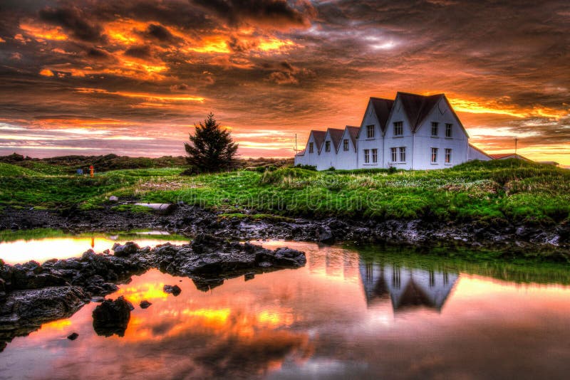 Vertical Shot of Buildings and the Cloudy Sky Reflecting on a Puddle ...