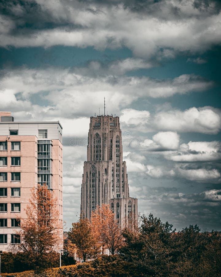 Vertical Shot of Buildings Under a Cloudy Blue Sky Stock Photo - Image ...