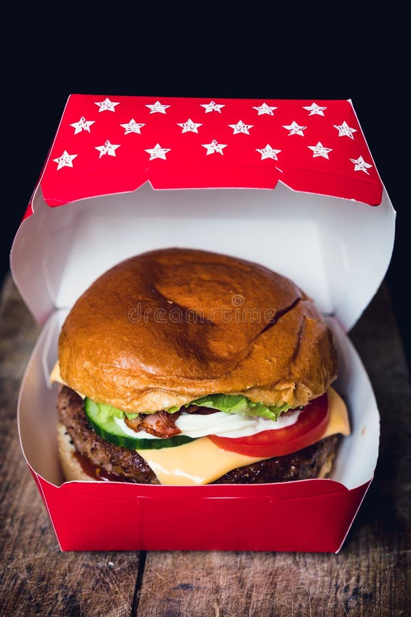 Vertical Shot of a Burger in a Red and White Packaging Stock Image ...