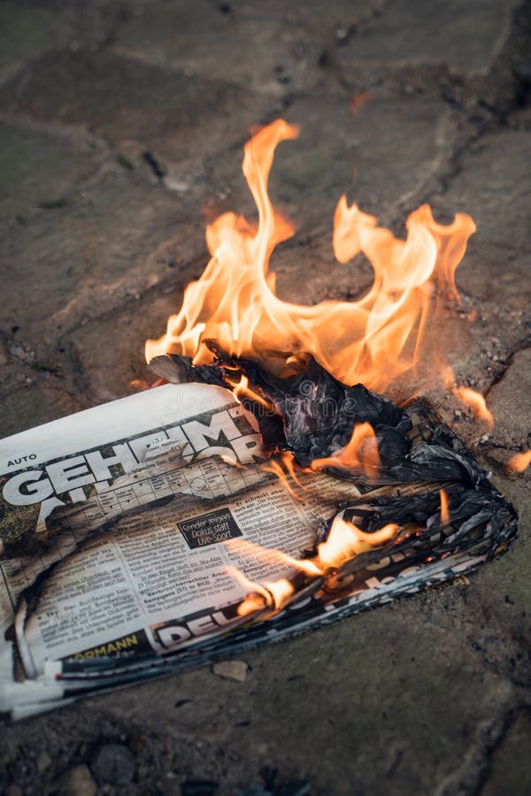 Vertical Shot of a Burning BILD Zeitung Newspaper on the Ground ...