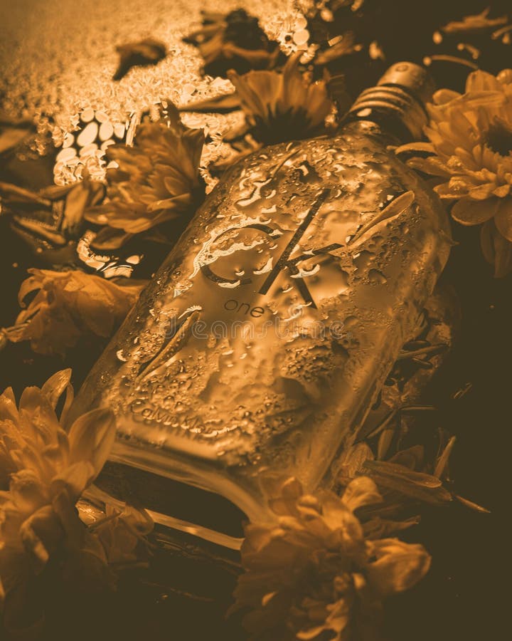 Vertical Shot of the Calvin Klein One Perfume with Flower Decorations ...