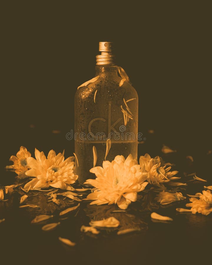 Vertical Shot of the Calvin Klein One Perfume with Flower Decorations ...