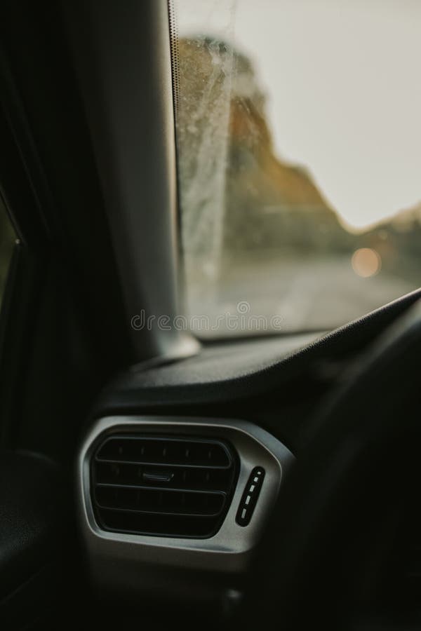 Vertical Shot of a Car Heater with Sunset Visible Behind Windshield in ...