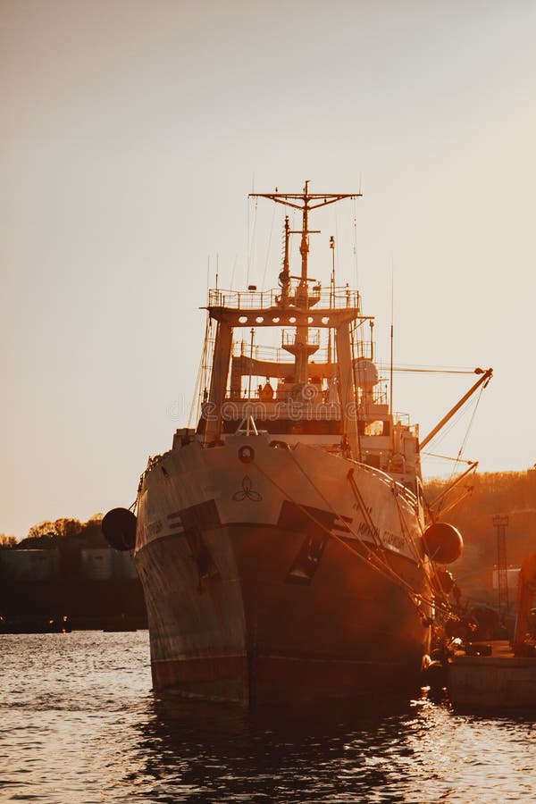 Vertical Shot of a Cargo Ship on the Water with Clear Blue Sky in the ...