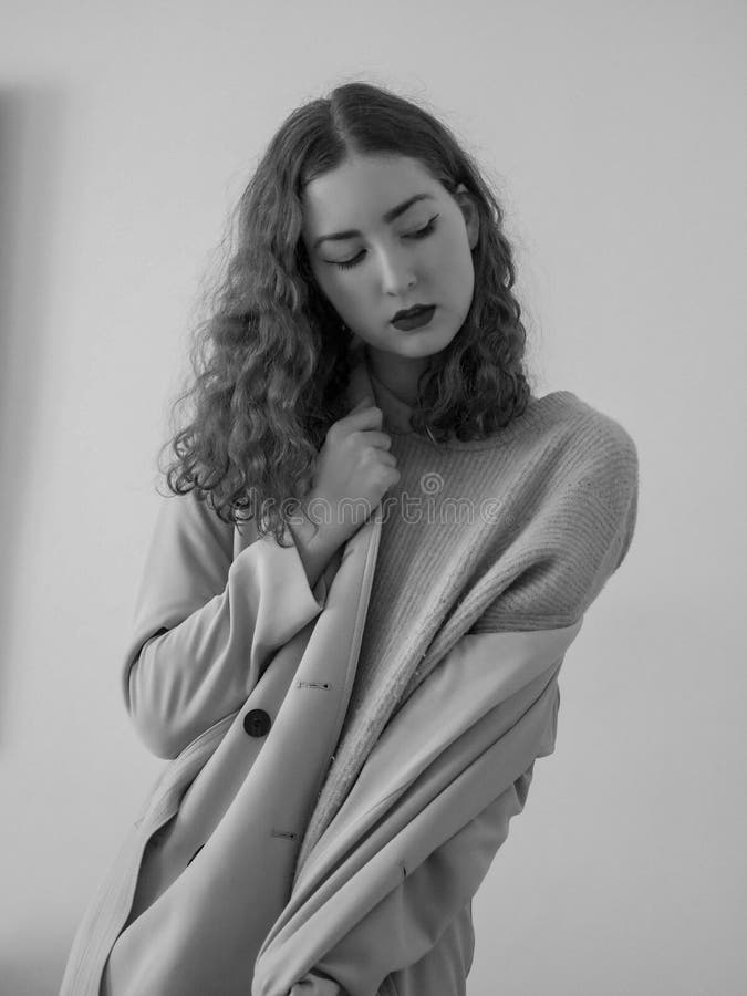 Vertical Shot of a Caucasian Brunette Model Looking Down and Holding the Trench Coat Stock Image ...