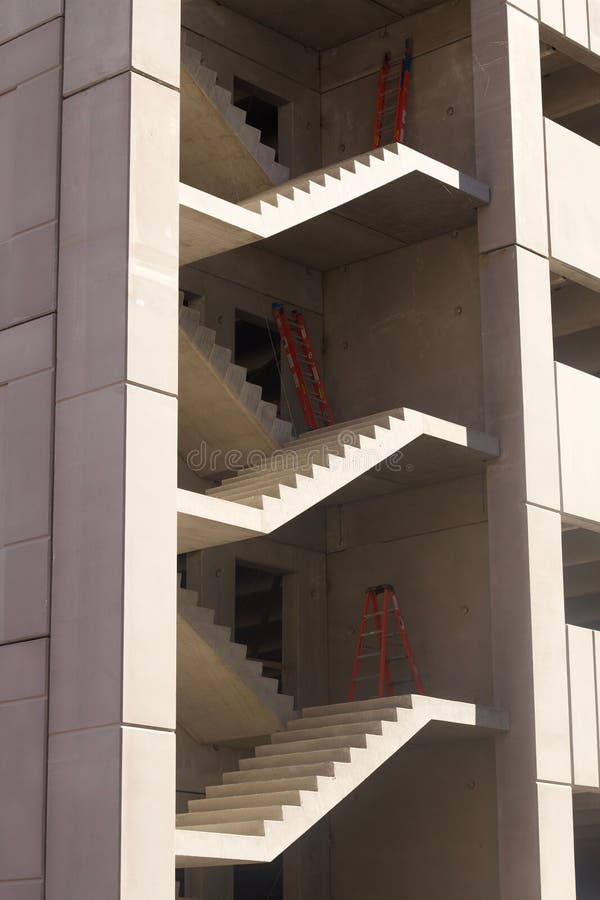 Vertical Shot of a Cement Staircase with Ladders in a Newly Constructed ...