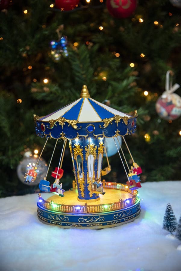 Vertical Shot of a Child Carousel Ornament with the Decorated Christmas ...