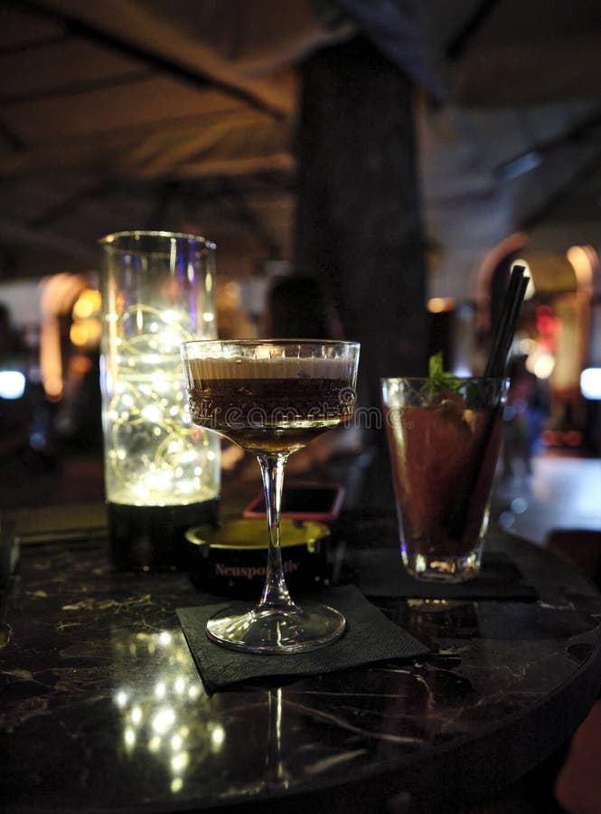 Vertical Shot of Classic Cocktail Drinks on Glasses on a Bar Counter ...