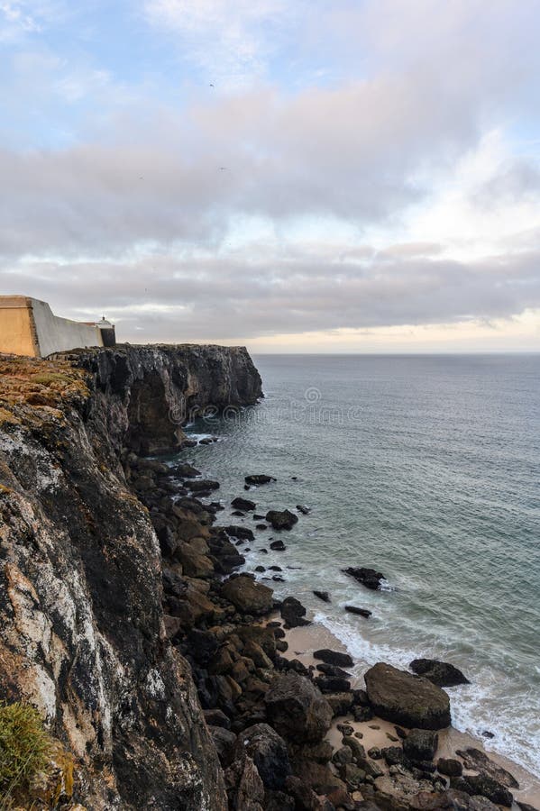 Vertical Shot of a Cliff and Stones on a Beach Stock Image - Image of ...