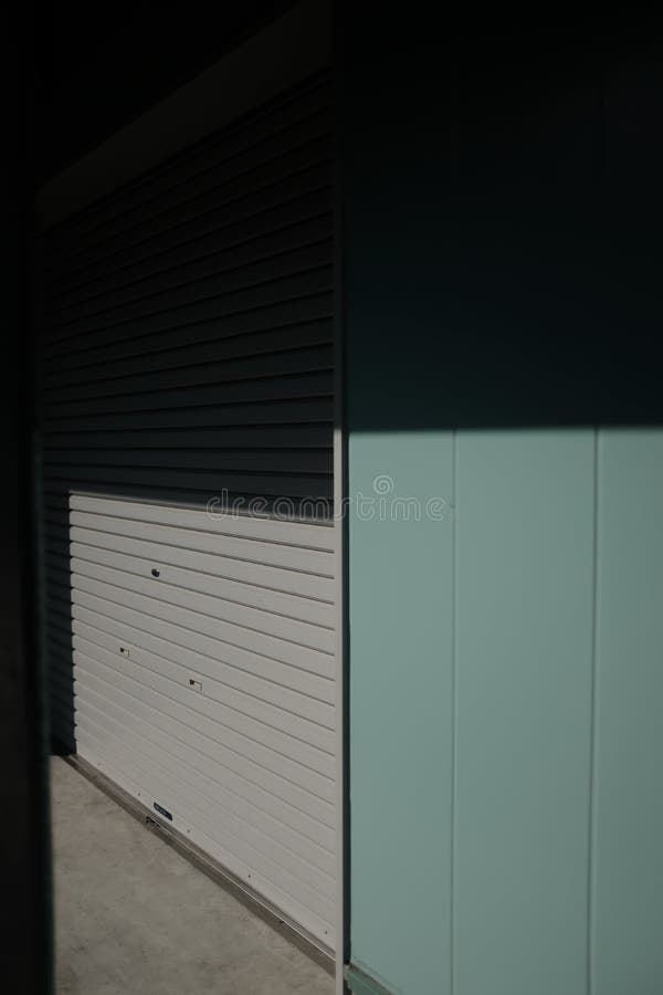Vertical Shot of a Closed Shutter Door Under the Sunlight Stock Photo ...