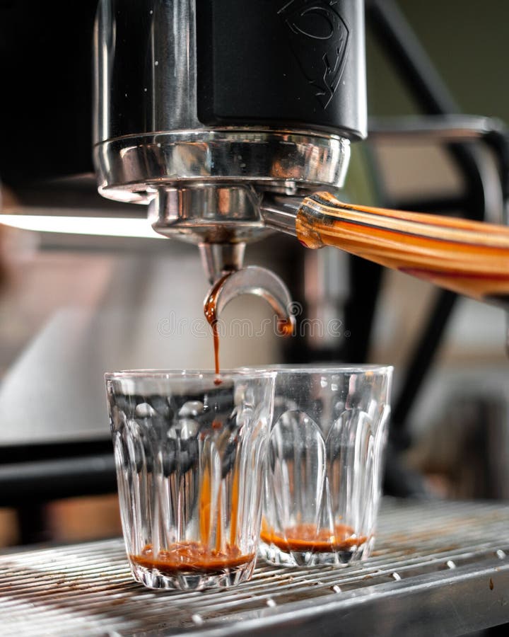 Vertical Shot of Coffee Dripping from the Machine into Glass Cups Stock ...