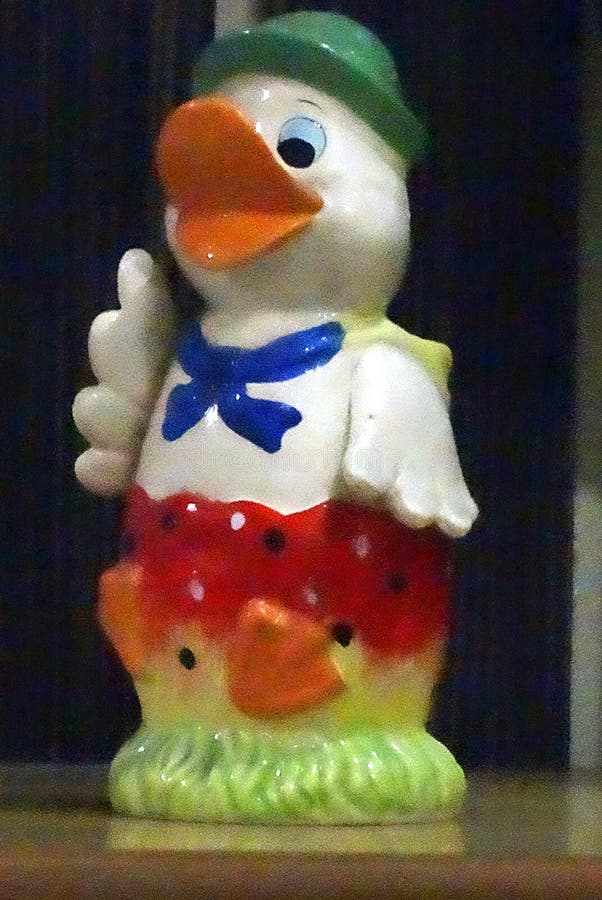 Vertical Shot of a Colorful Duck Toy with a Green Hat on the Table ...