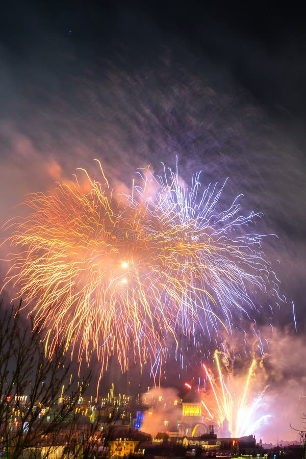 Vertical Shot of the Colorful Fireworks Over a City in the Night Sky ...