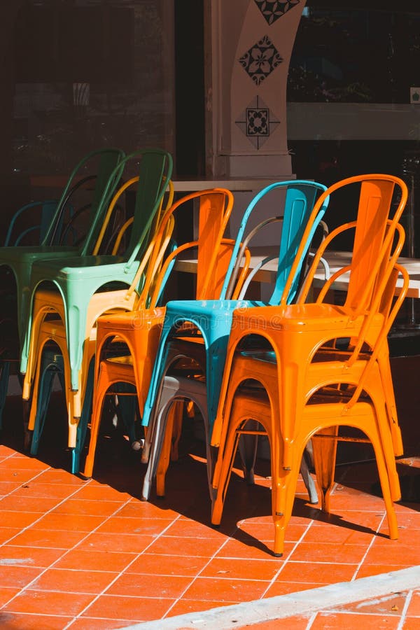 Vertical Shot of Colorful Plastic Chairs Stacked Outdoors Stock Image ...