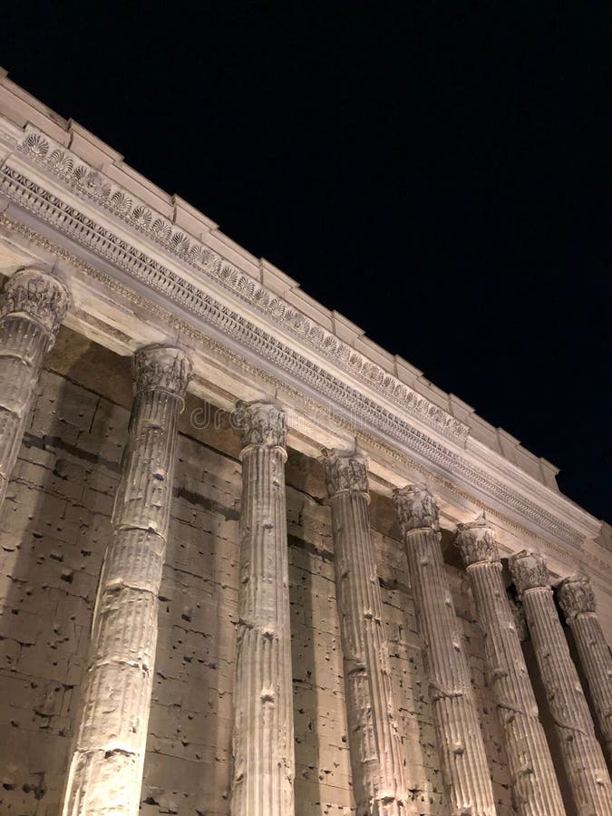 Vertical Shot of the Columns of the Temple of Hadrian in Rome at Night ...