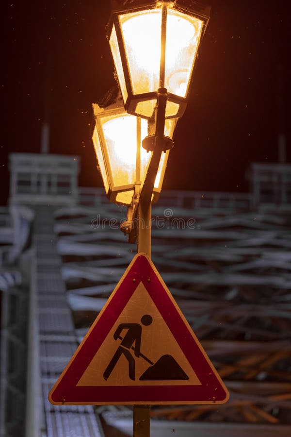 Vertical Shot of a Construction Work Sign on a Lamp Pole Stock Photo ...