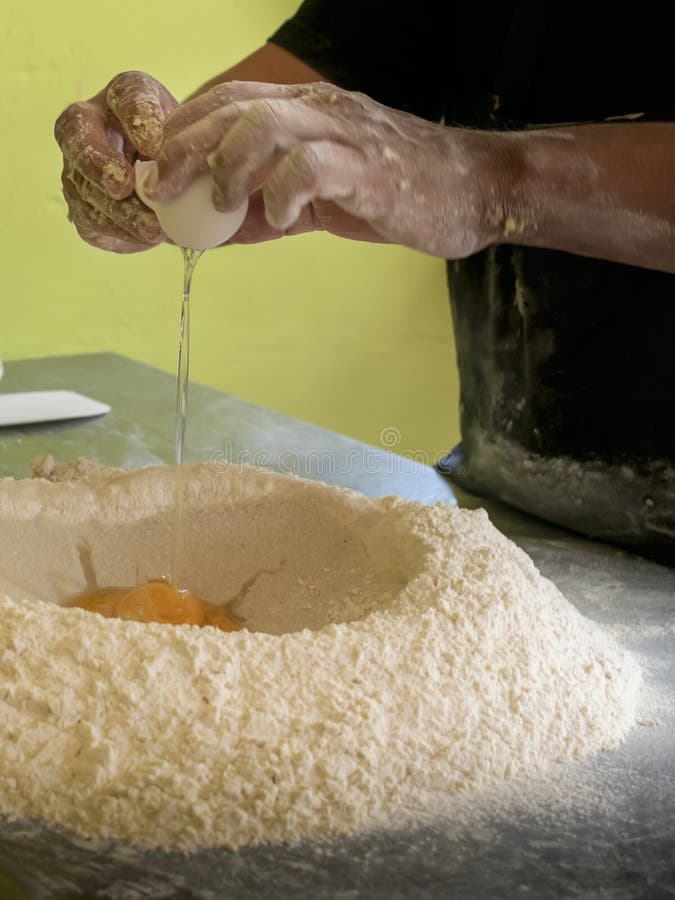 Vertical Shot of a Cook Adding an Egg To the Flour Stock Photo - Image ...