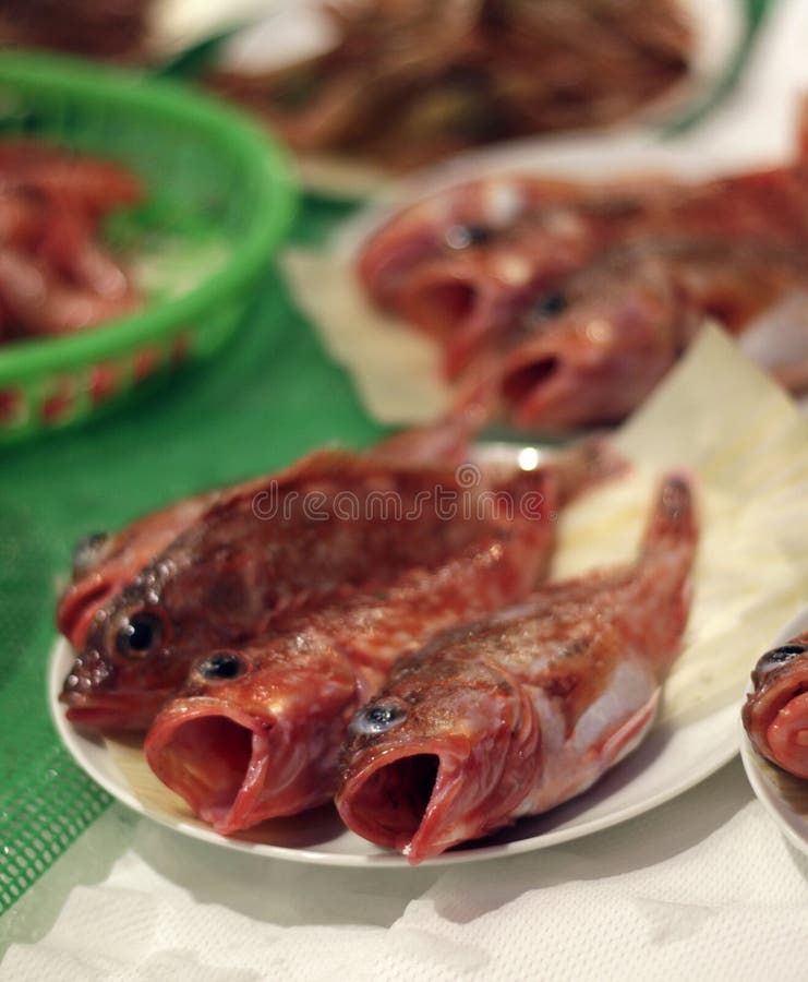 Vertical Shot of Cooked Fish Put on a Plate Over the Table Stock Image ...