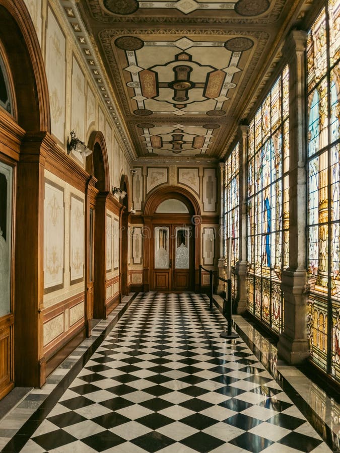 Vertical Shot of a Corridor with Stained Glass Windows in the ...