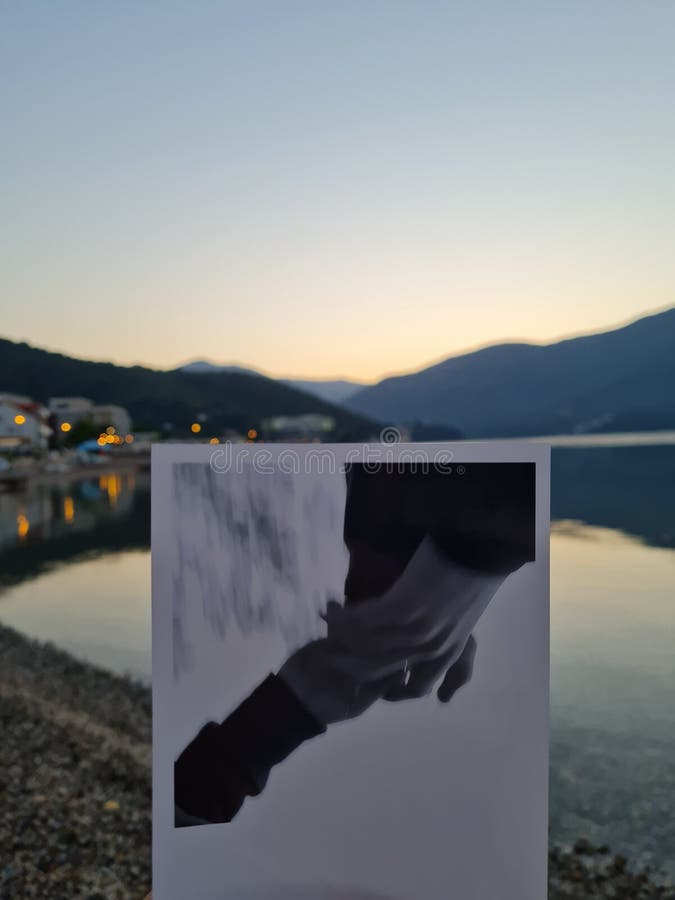 Vertical Shot of a Couple of Hands Picture on a Seaside at Sunset Stock ...