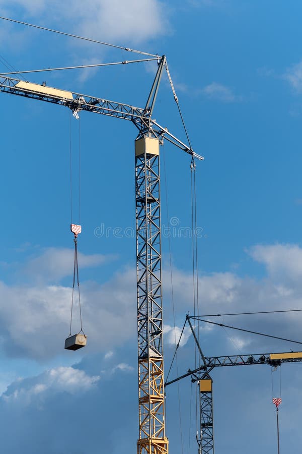 Vertical Shot of a Crane Carrying Cargo on a Construction Site Stock ...