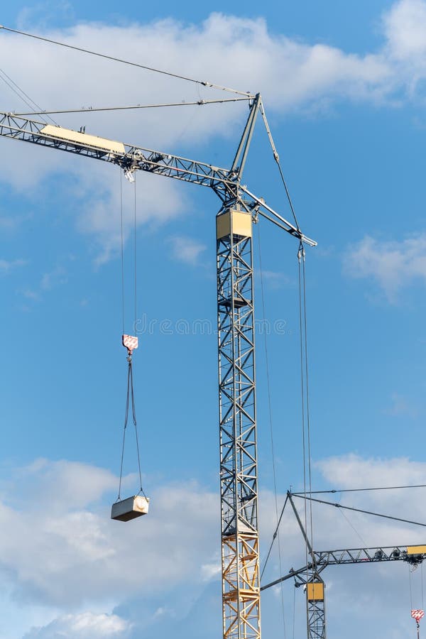 Vertical Shot of a Crane in the Construction Site on a Sunny Day Stock ...