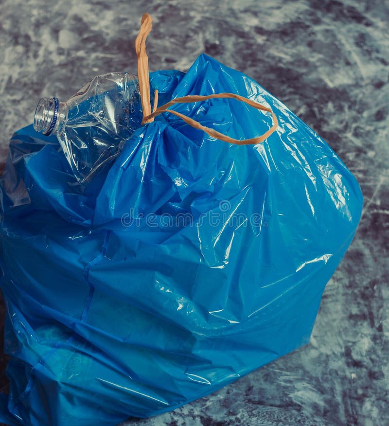 Vertical Shot of a Crushed Plastic Bottle on a Blue Trash Bag Stock ...