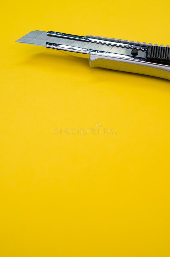 Vertical Shot of a Cutter Blade Tool Isolated on Yellow Background ...