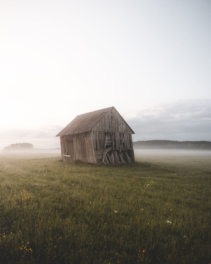 Vertical Shot of a Damaged Wooden Hut in the Meadow Stock Image - Image ...