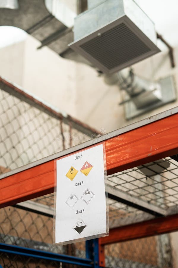 Vertical Shot of Danger Signs on a Red Metal Frame with a Blurred ...