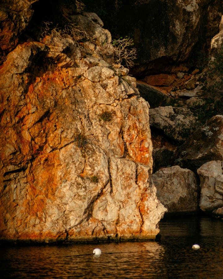 Vertical Shot of the Dark Brown Cliff S Rough Surface. Stock Photo ...