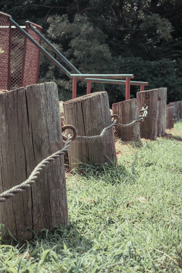 Vertical Shot of a Decorative Fence with Ropes and Stumps Stock Photo ...