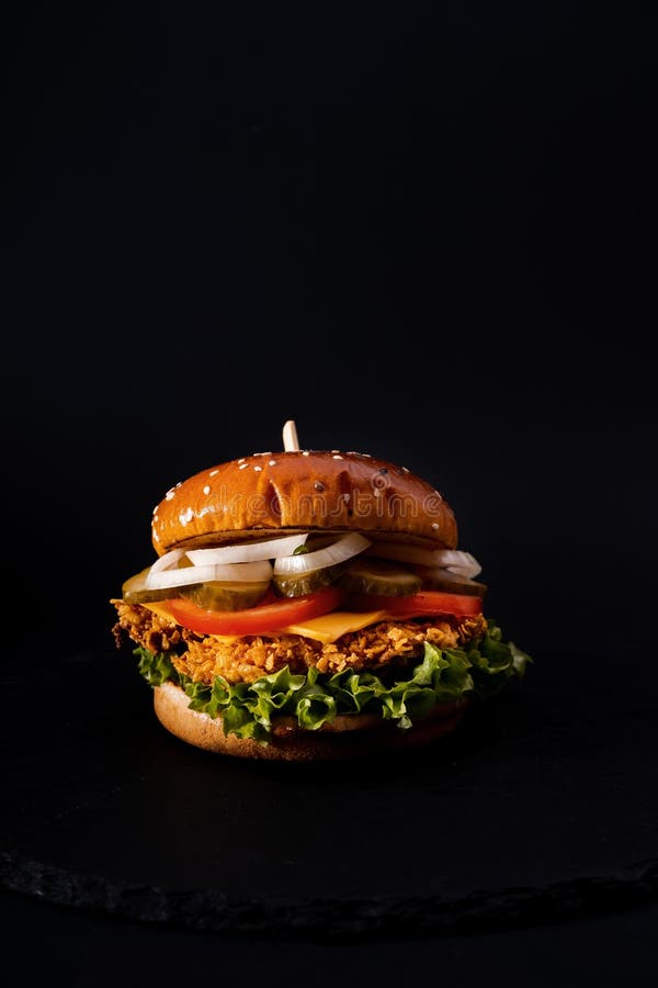 Vertical Shot of a Delicious Burger on a Black Surface Stock Photo ...