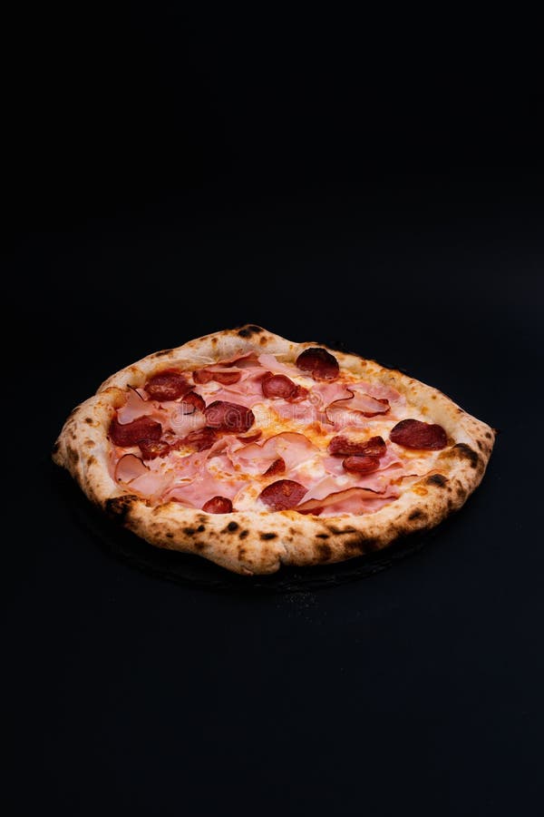 Vertical Shot of a Delicious Pizza on a Black Surface Stock Photo ...
