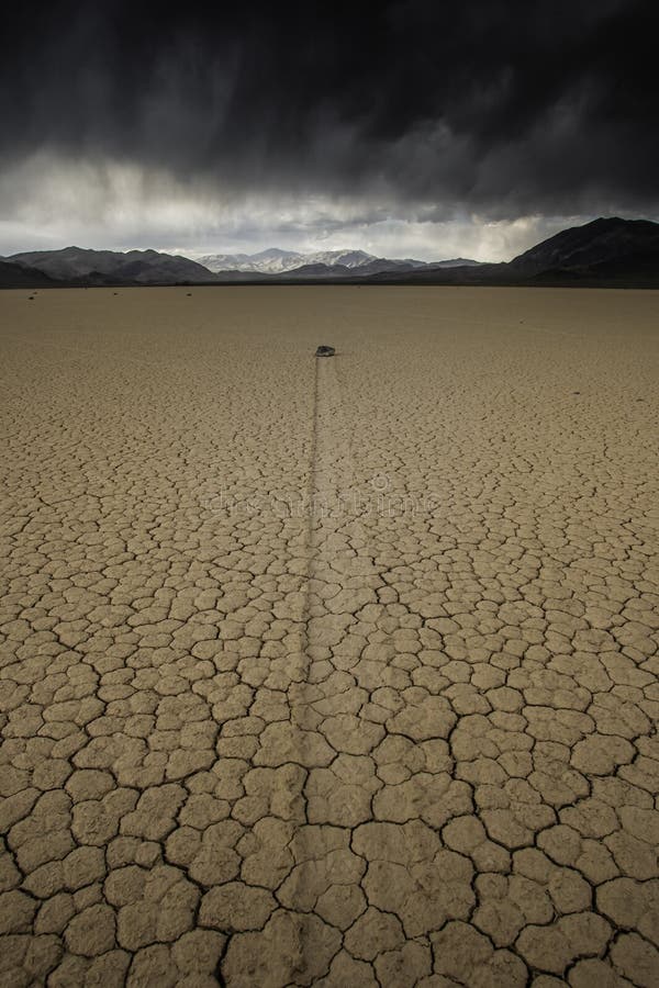 Vertical Shot of a Deserted Ground of Sand Surrounded by a Mountainous ...