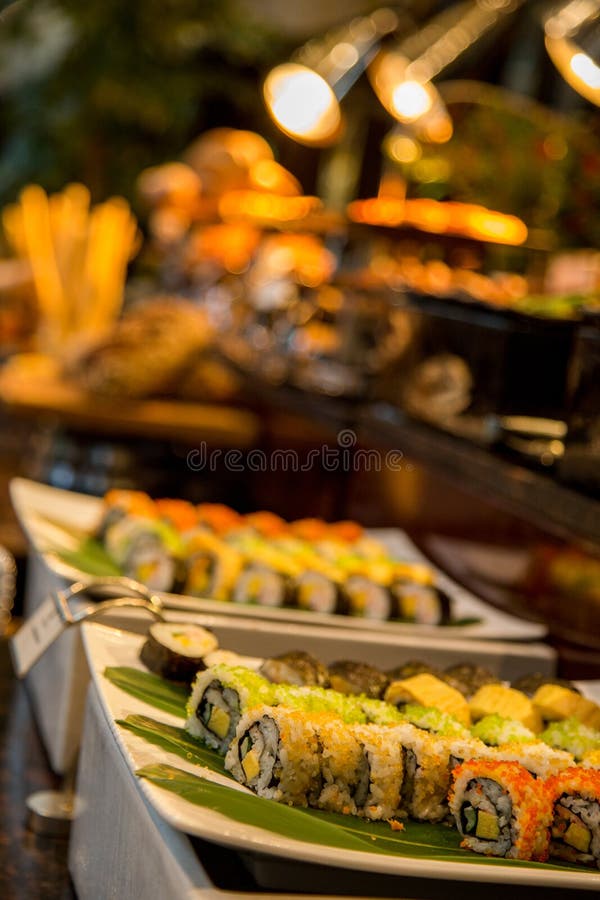 Vertical Shot of Different Sushi Types on Plates on the Table in a ...