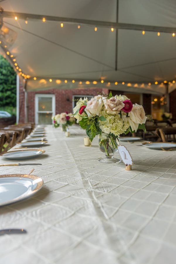 Vertical Shot of a Dining Table with Floral Centerpiece at a Wedding ...