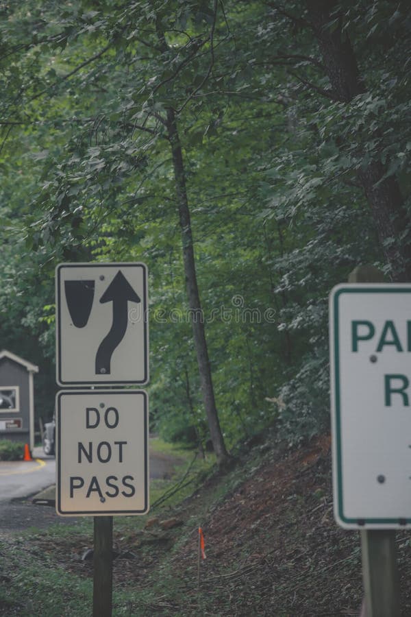 Vertical Shot of Do Not Pass Sign Text in the Forest with Trees Stock ...