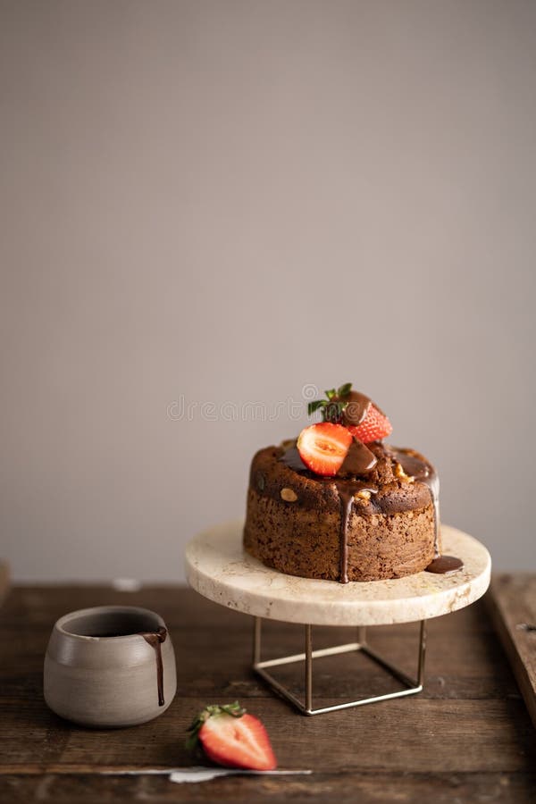 Vertical Shot of a Dripping Chocolate Cake with Strawberries on a Cake ...