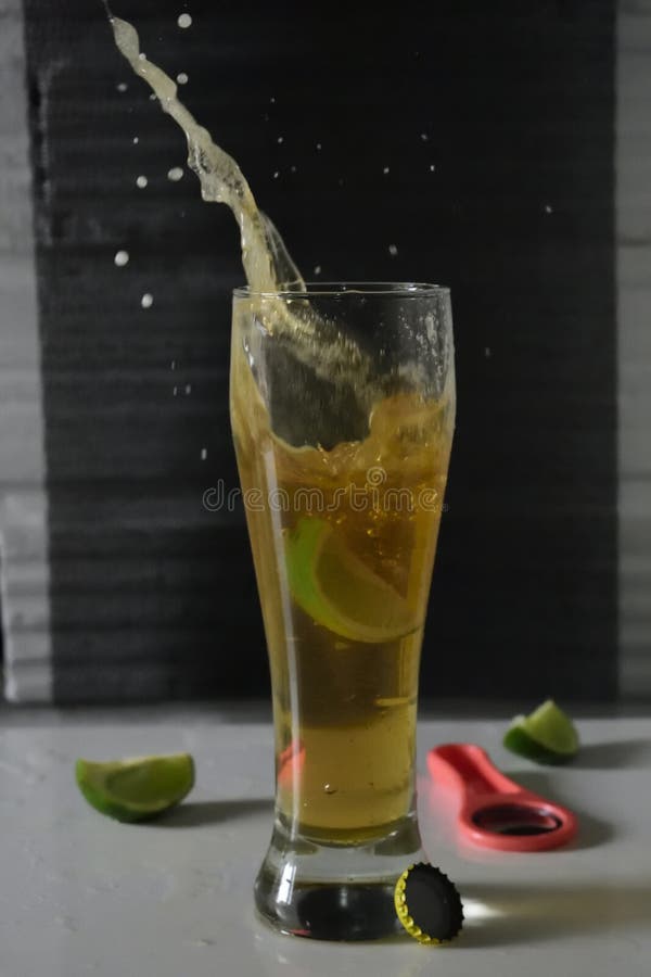 Vertical Shot of a Drop of Lime with a Splash of Cold Beer Stock Photo ...