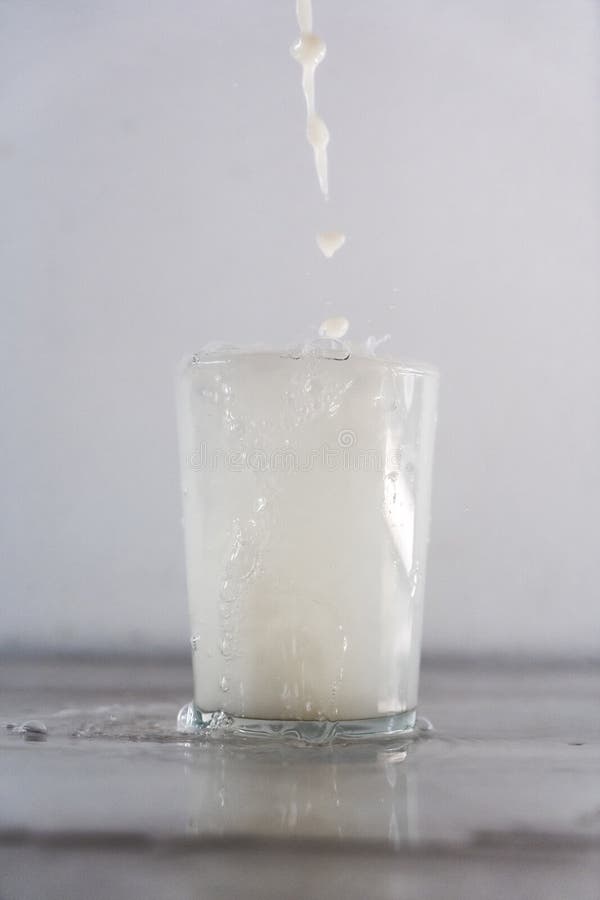 Vertical Shot of Dropping White Liquid in a Glass Cup Stock Photo ...