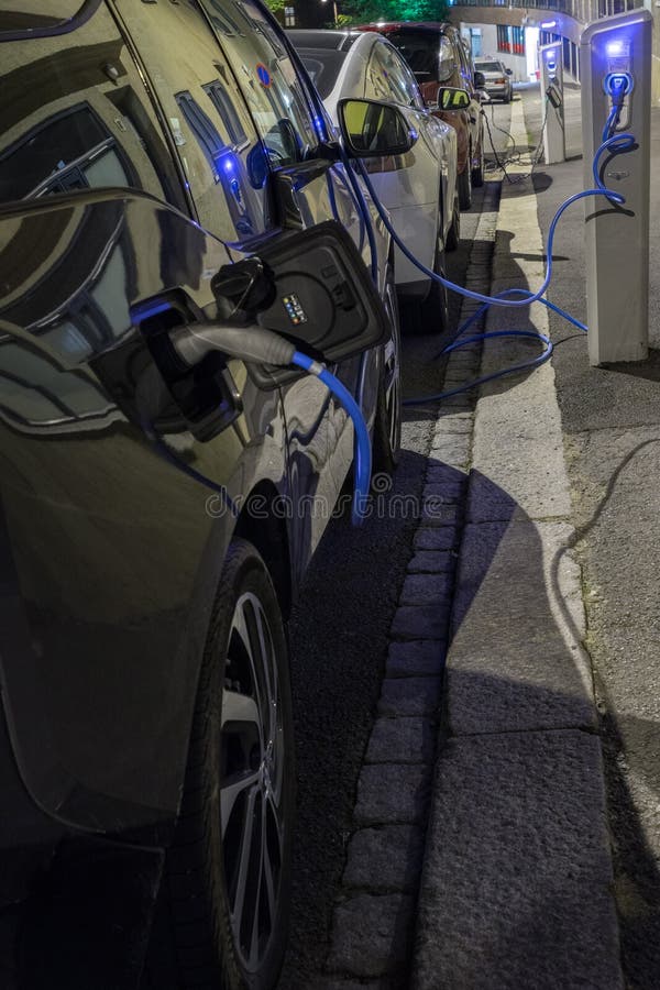 Vertical Shot of Electric Cars Charging at Night Stock Image - Image of ...