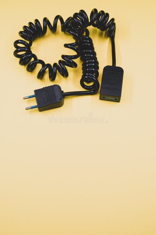 Vertical Shot of an Electrical Cable on a Yellow Surface Stock Image ...