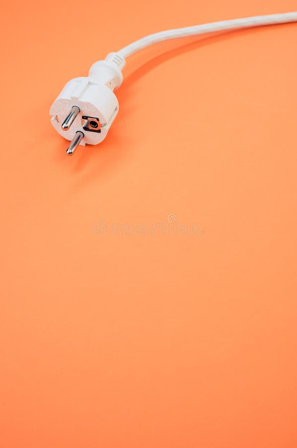 Vertical Shot of an Electrical Wire and Plug on an Orange Surface Stock ...