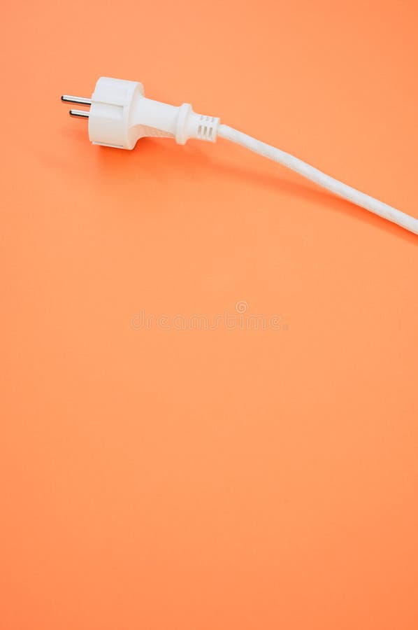 Vertical Shot of an Electrical Wire and Plug on an Orange Surface Stock ...