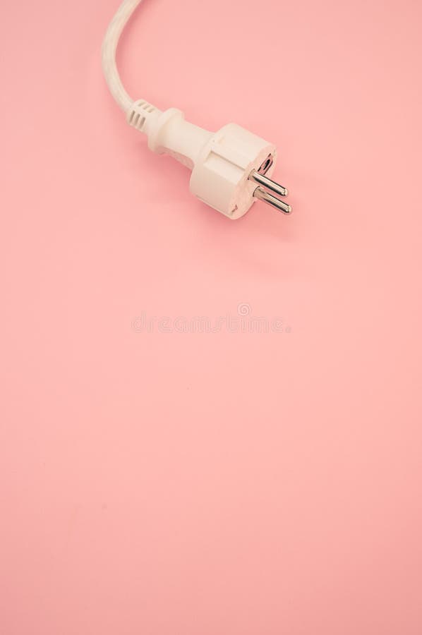 Vertical Shot of an Electrical Wire and Plug on a Pink Surface Stock ...