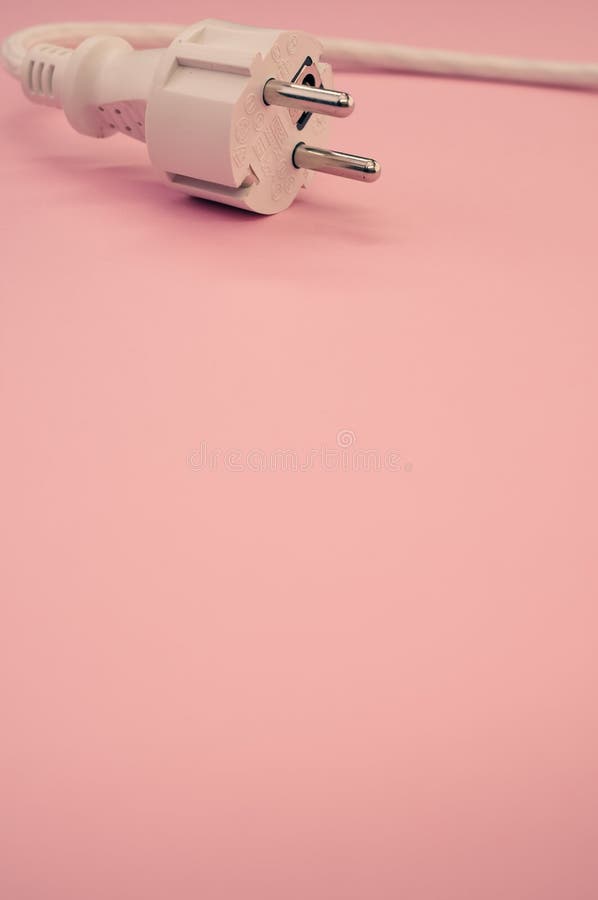 Vertical Shot of an Electrical Wire and Plug on a Pink Surface Stock ...