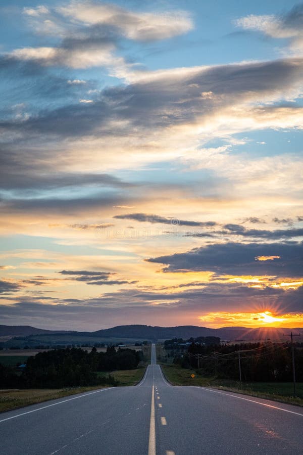 Vertical Shot of an Empty Road with Mountains in the Background at ...